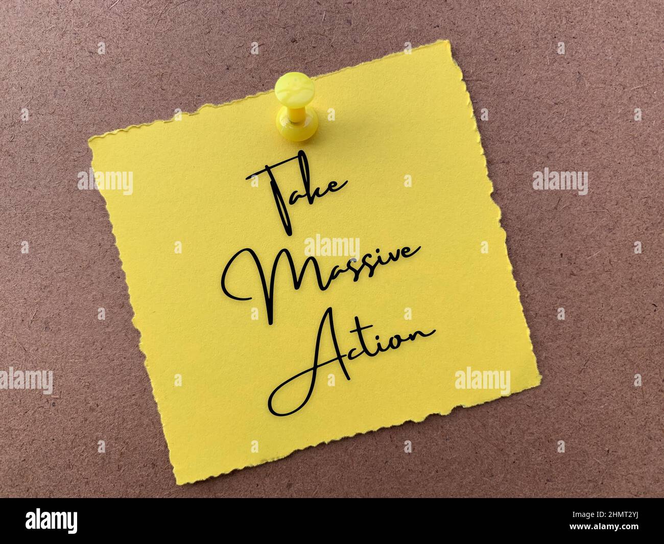 Take massive action text on yellow notepad Stock Photo - Alamy