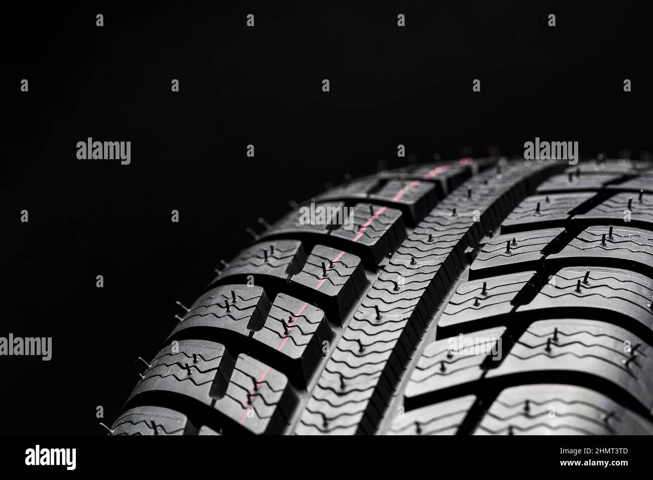 Winter Car tires close-up wheel profile structure on black background Stock Photo - Alamy