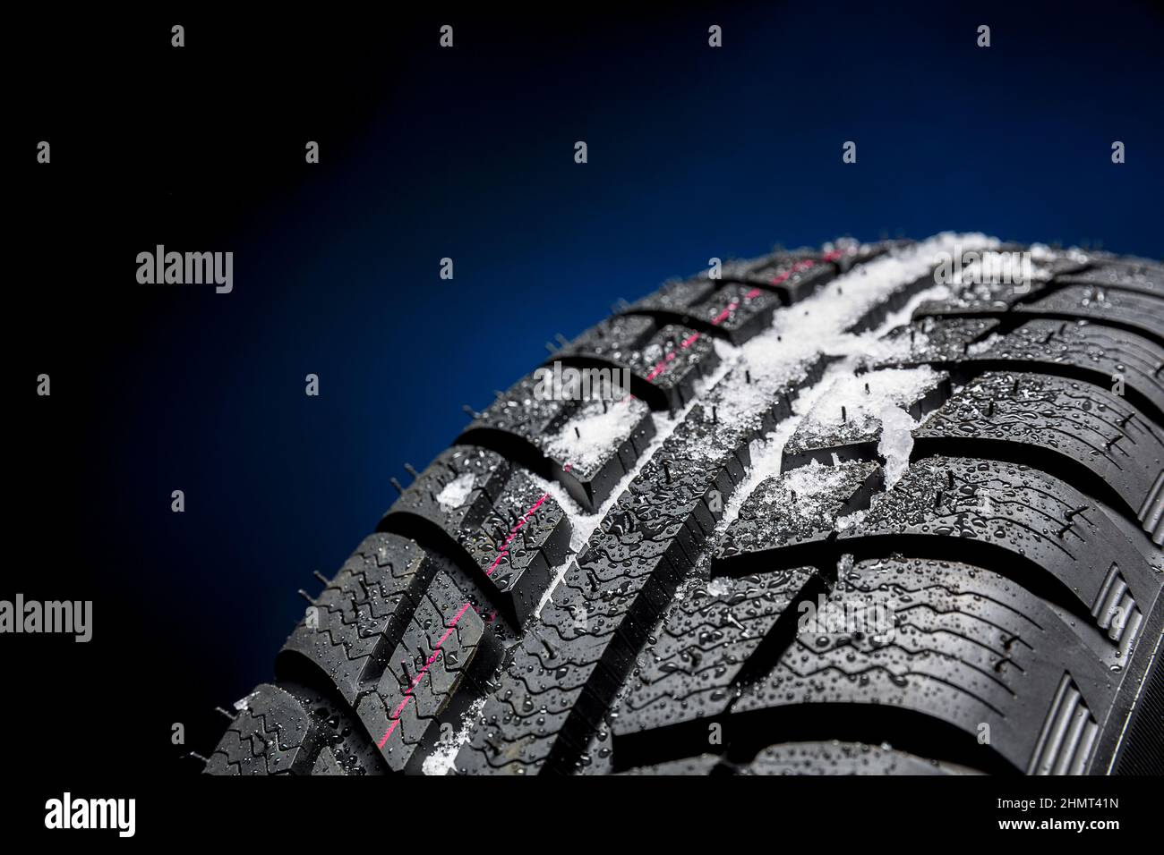 Winter Car tires with snow close-up wheel profile structure on black blue background Stock Photo ...