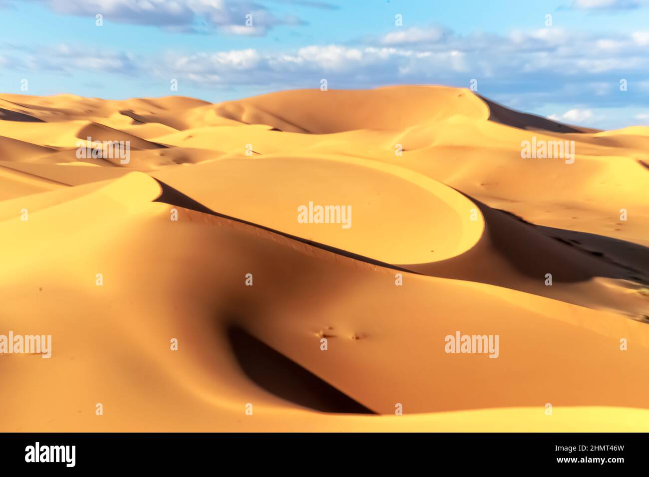 Contrasted shapes and shadows of golden yellow and orange colored sand ...