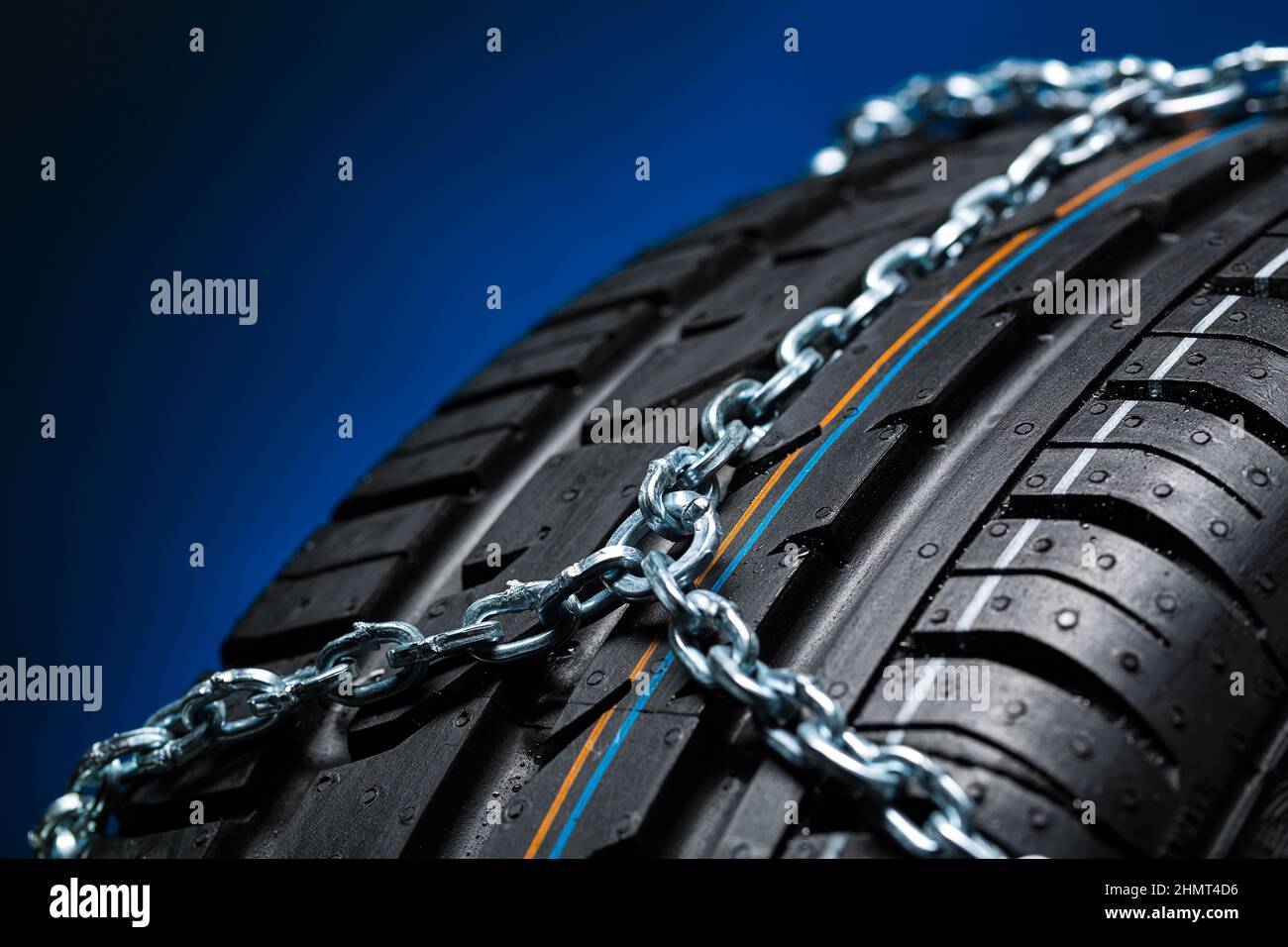 Car tyre with snow chain for winter Stock Photo - Alamy