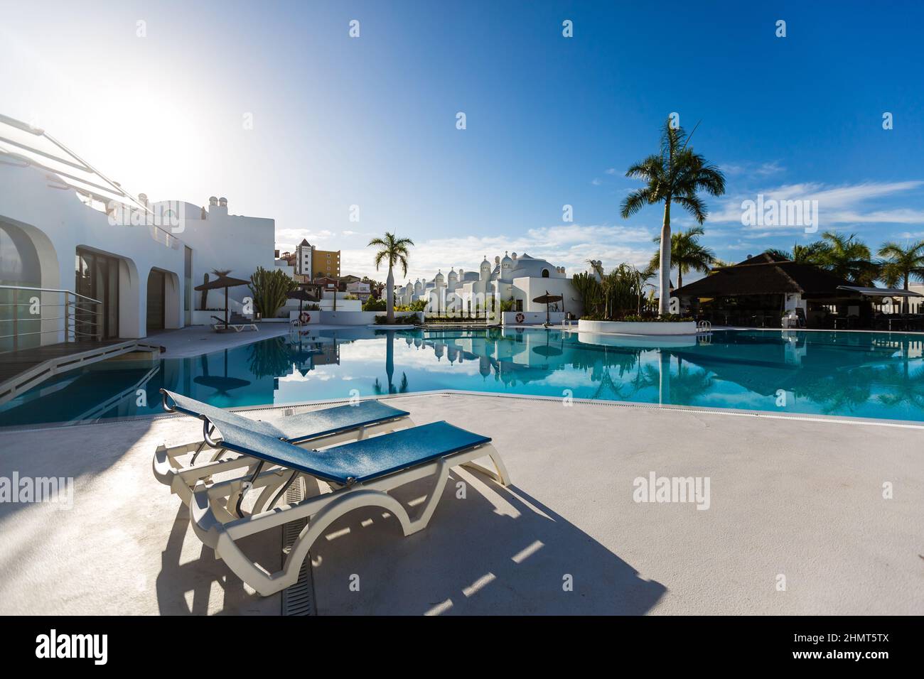 swimming pool with empty sun loungers Stock Photo - Alamy