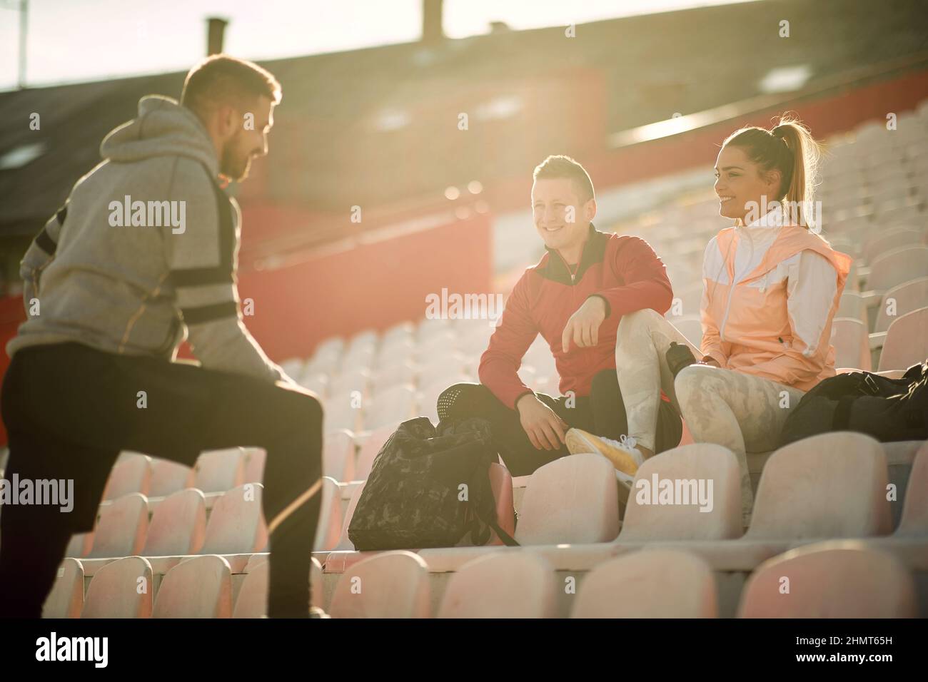 Group of athletes hanging out after the training Stock Photo - Alamy
