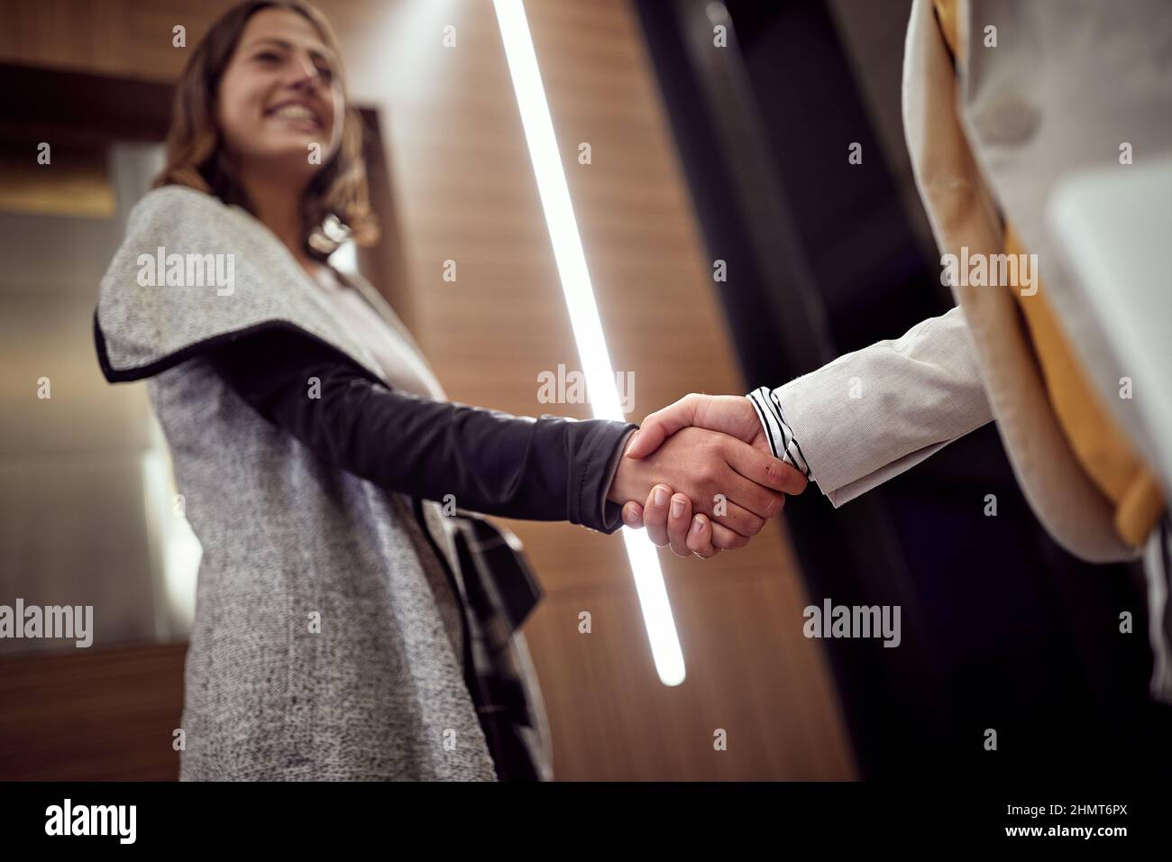 Two female colleagues met in the hall at work in a friendly atmosphere ...