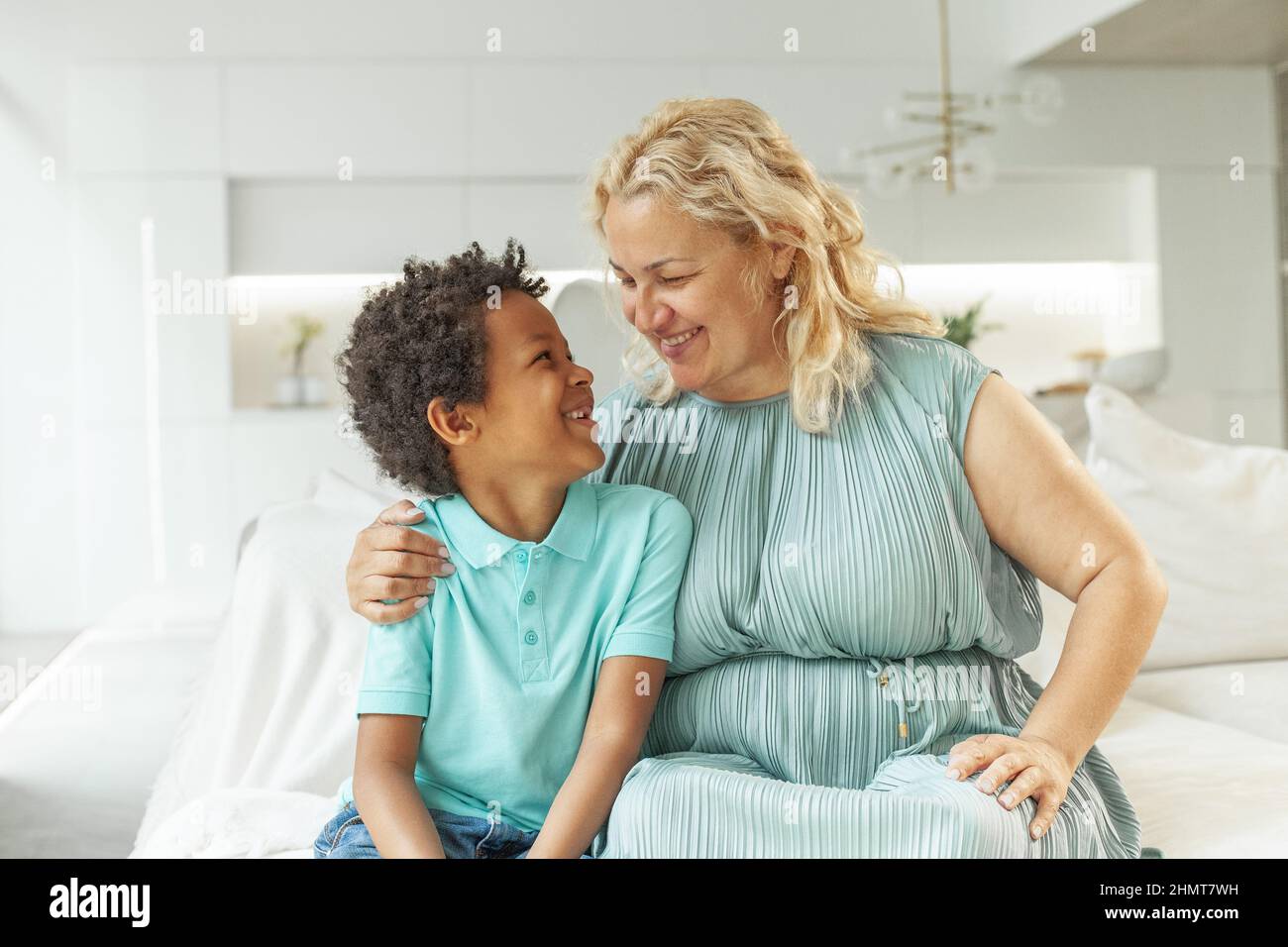 Happy family portrait. Mother and child laughing and looking at each other at home Stock Photo ...