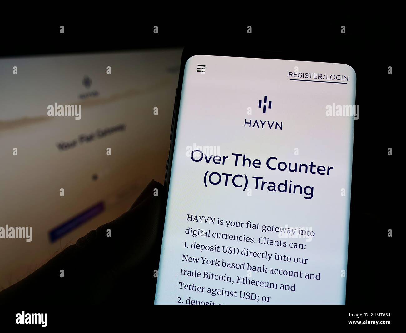 Person holding smartphone with webpage of financial services company ...