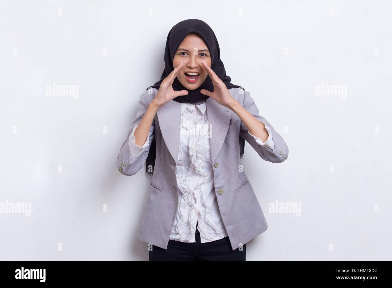 young asian beautiful muslim woman shouting and yelling announcing ...