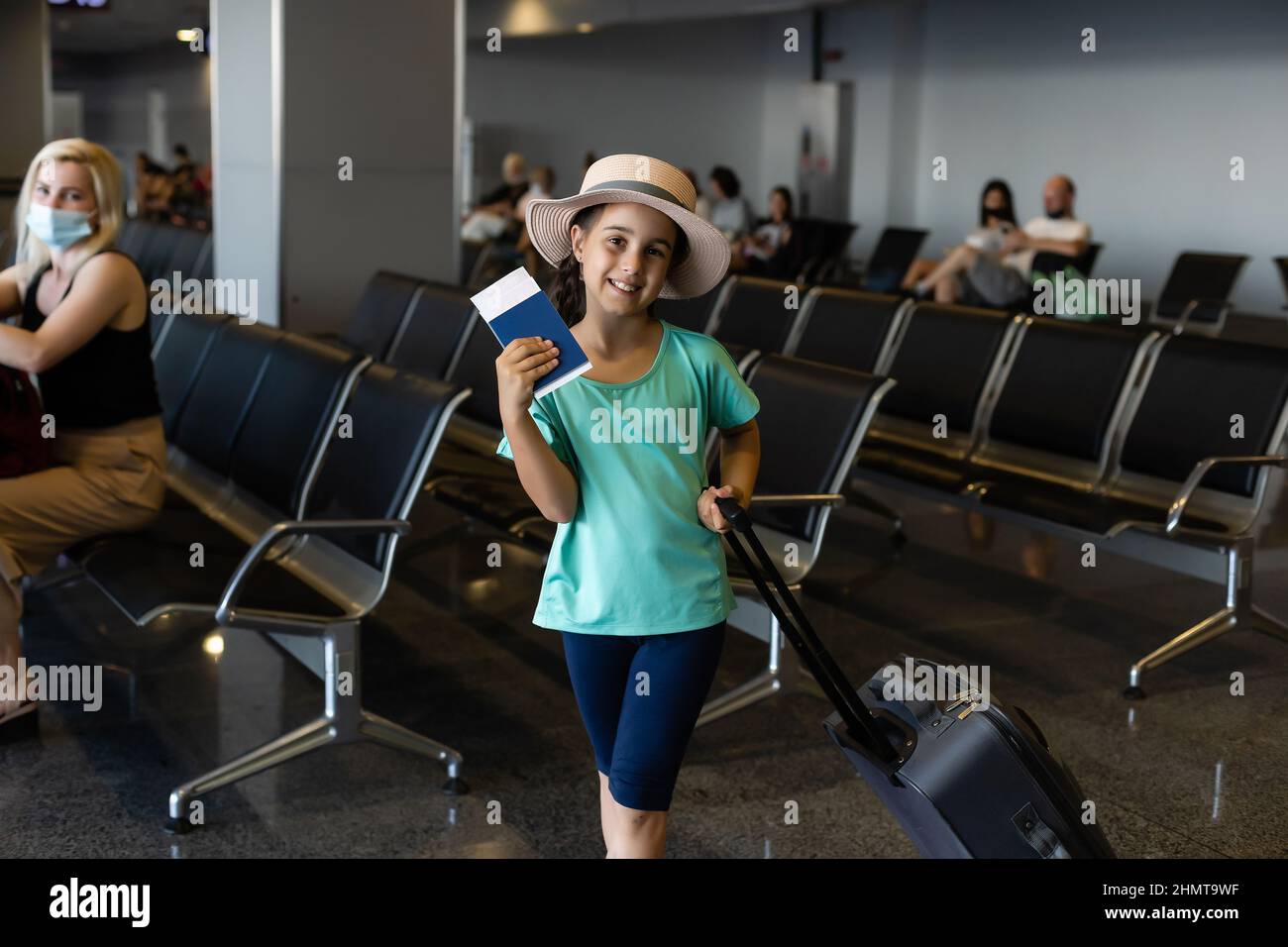 beautiful little girl holding passport and boarding pass at airport ...