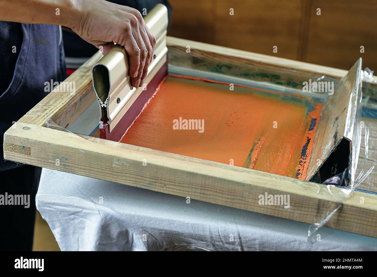male hand with a squeegee. serigraphy production selective focus photo ...