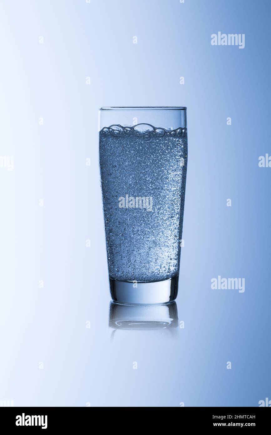 Water glass with sparkling carbonated on blue background with reflex drink drinking water Stock ...