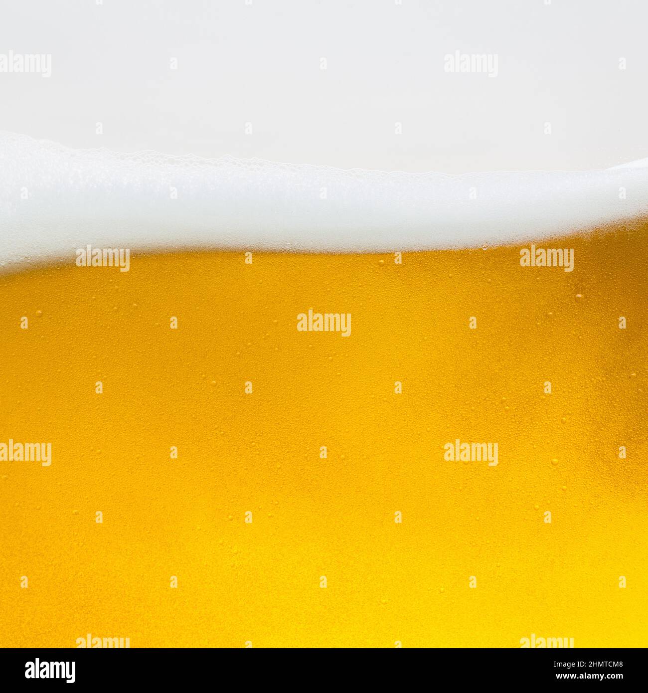 Beer foam wave with condensation waterdrops and bubbles on golden ...