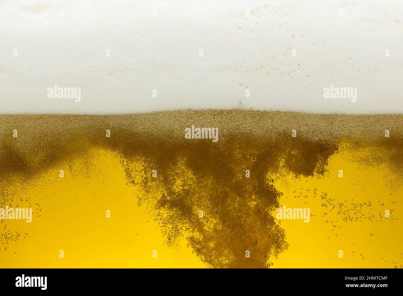 Beer with bubbles on golden Background Stock Photo - Alamy
