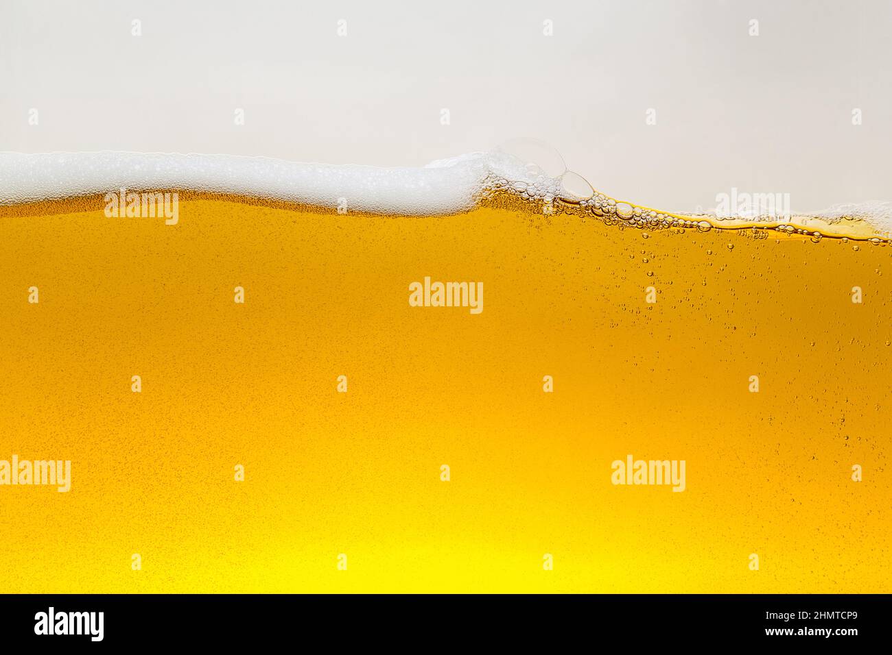 Golden Beer wave with foam and bubbles Stock Photo - Alamy