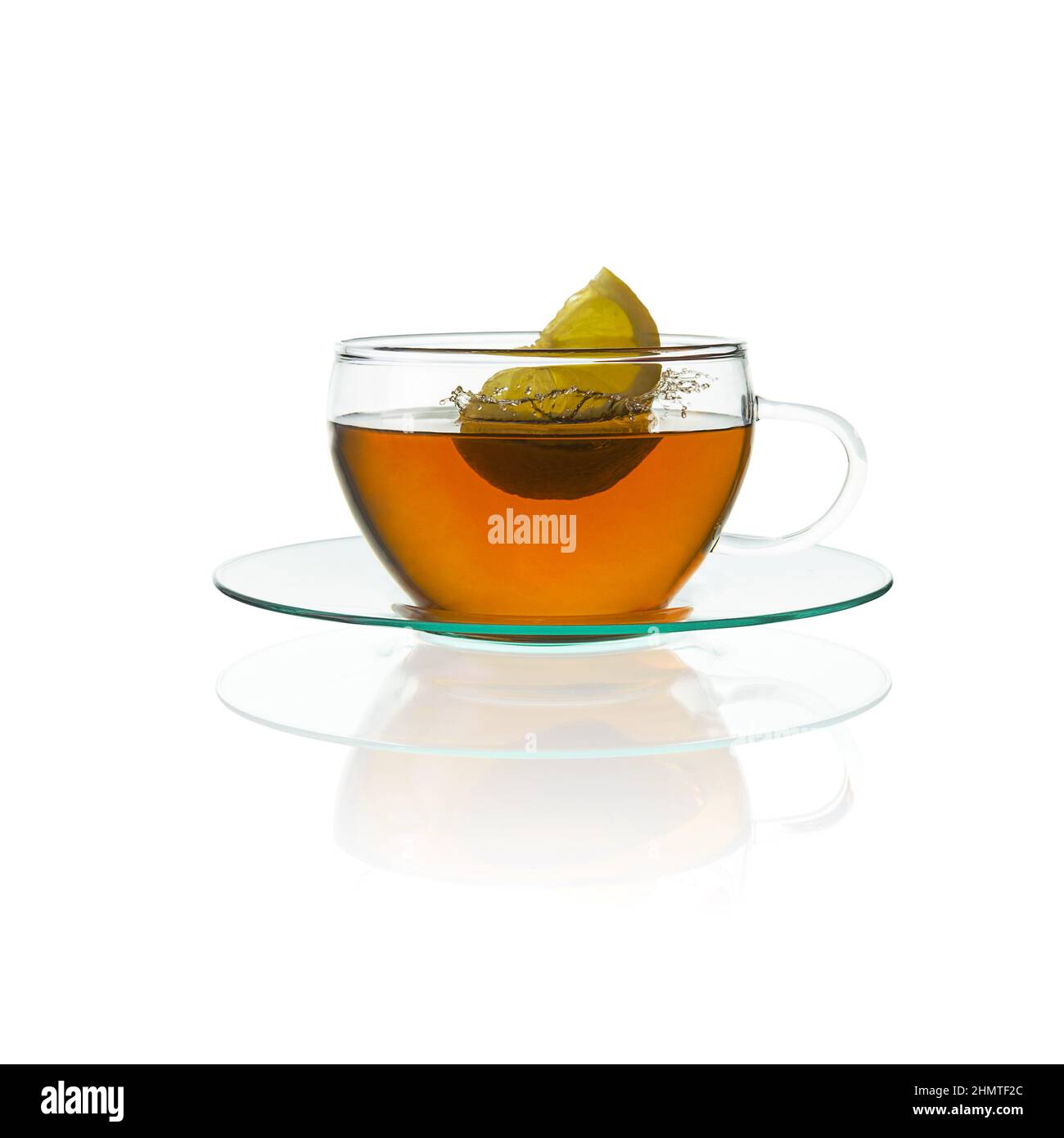 Tea cup glass teapot with a lemon citrus splash hot drink isolated on ...