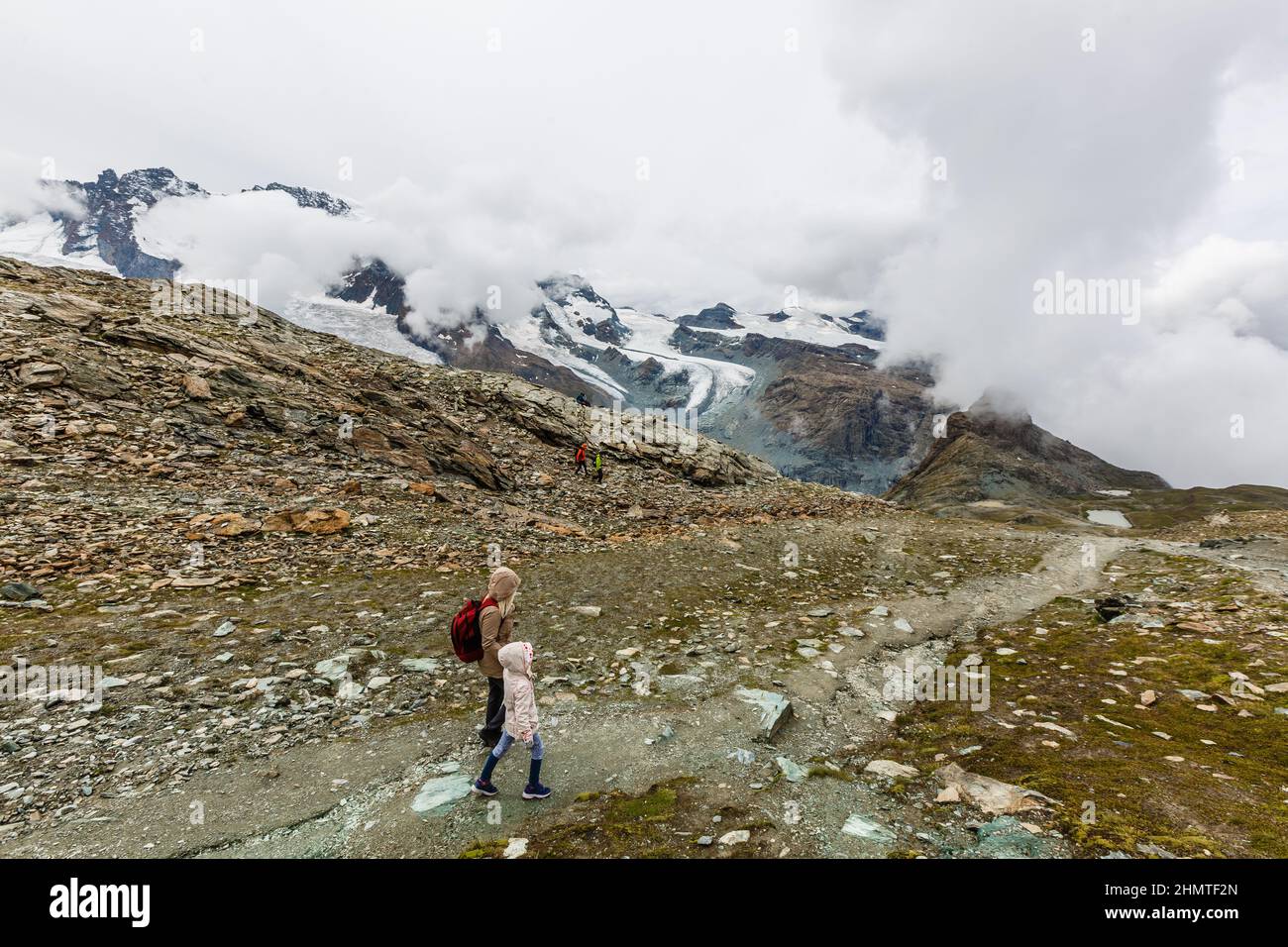 Mother and to children going for a walk in mountain surroundings Stock ...