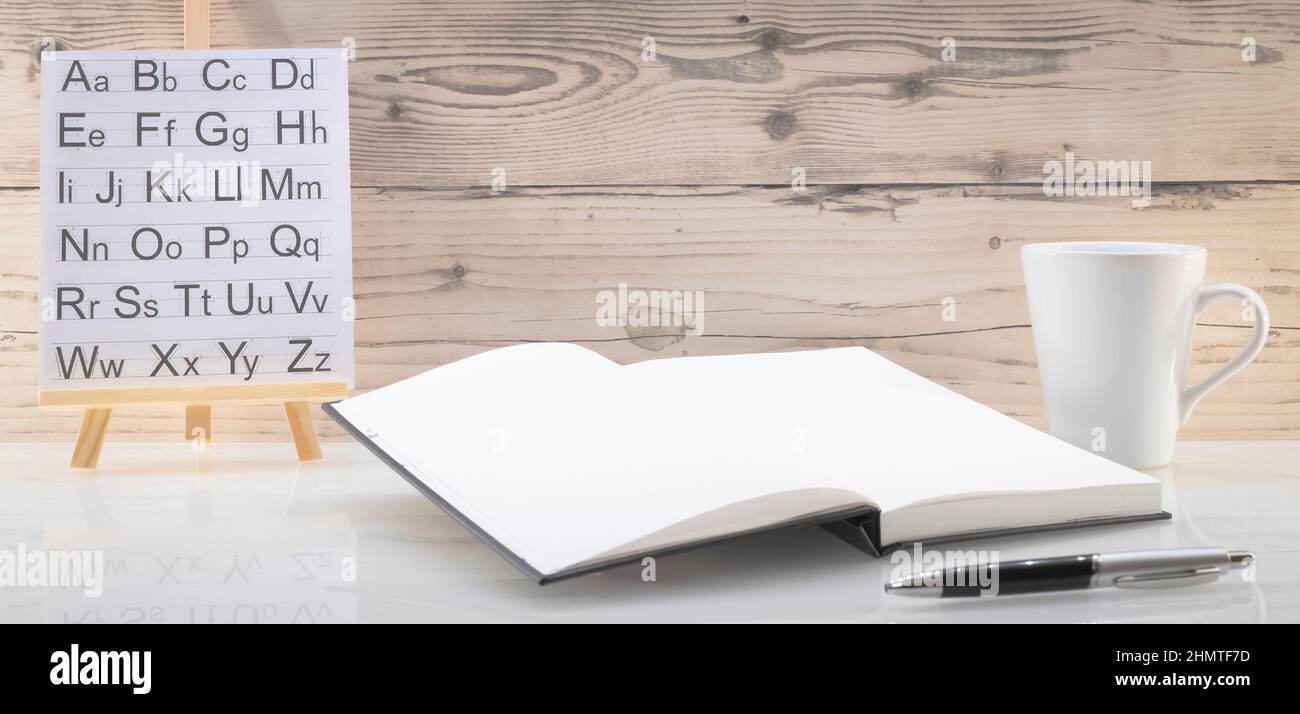 Open book on a workspace with sheets without writing Stock Photo - Alamy
