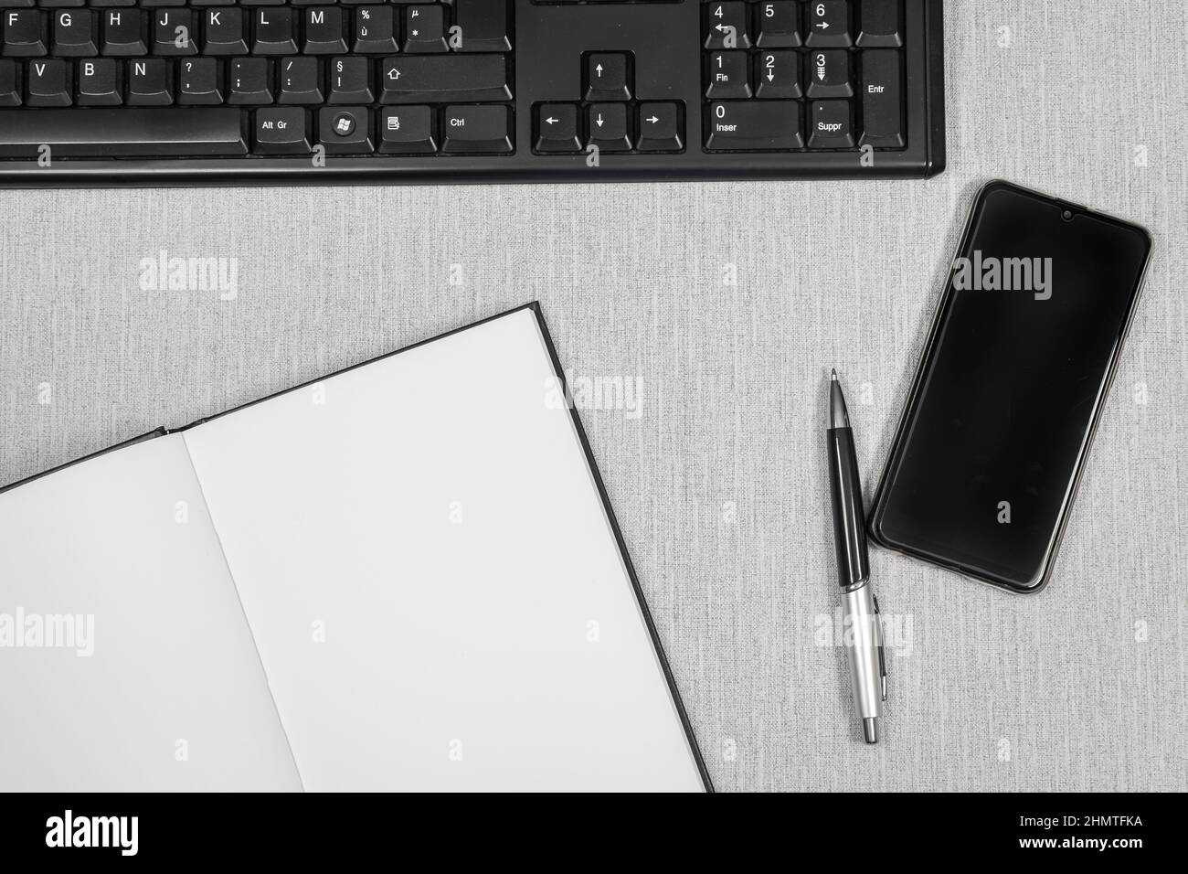 Open book on a workspace with sheets without writing Stock Photo - Alamy