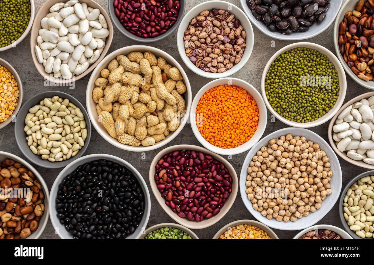 Different types of legumes in bowls, green with yellow peas and mung ...