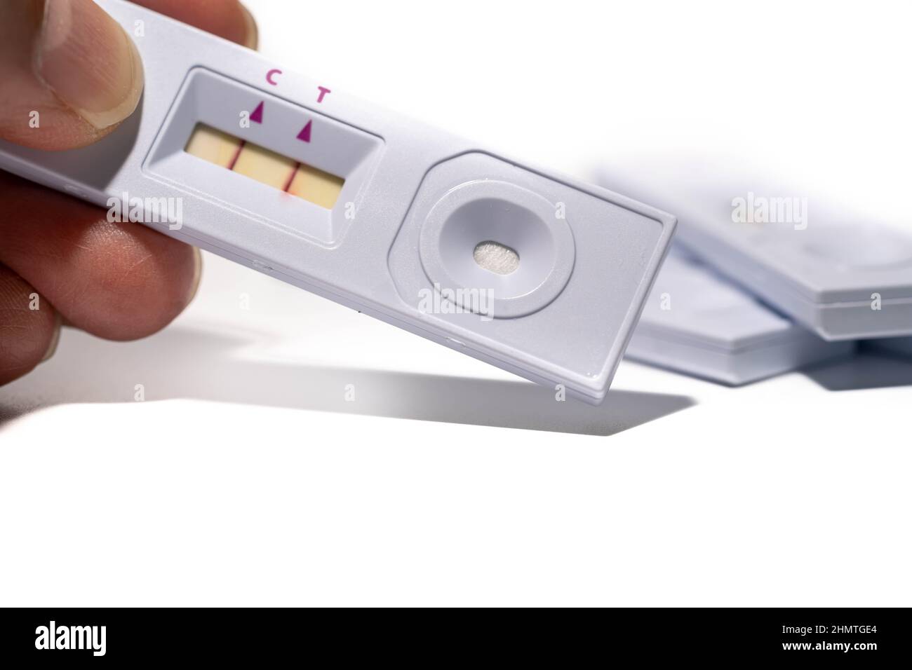 hand holding a positive antigen test result. Covid positive test result ... hand holding a positive antigen test result. Covid positive test result ...