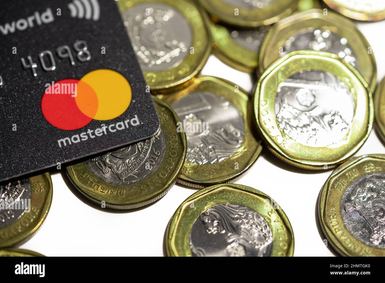 Mastercard credit card and singapore dollar coins. Financial and bank ...