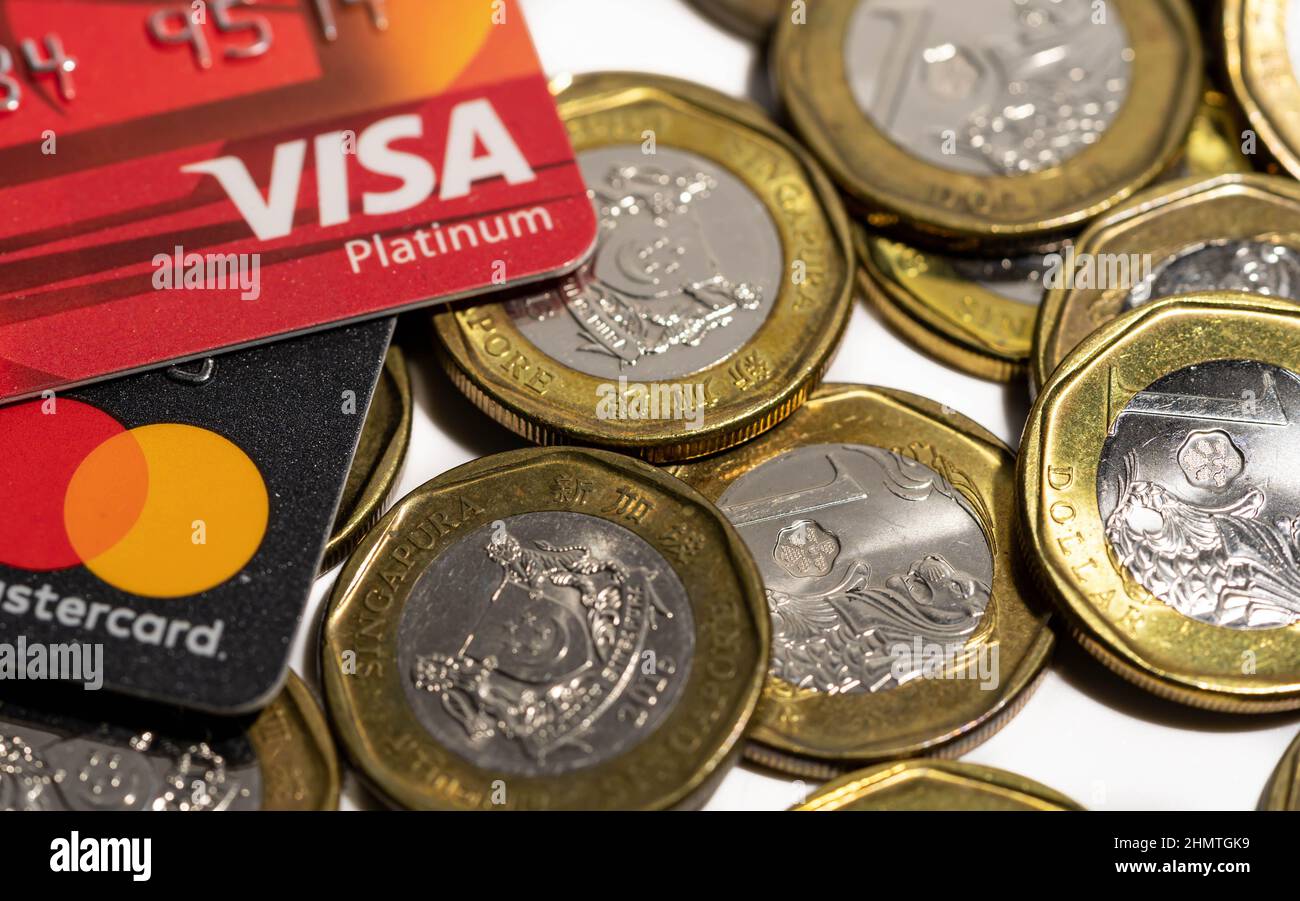 Visa and mastercard credit card and singapore dollar coins. Financial ...