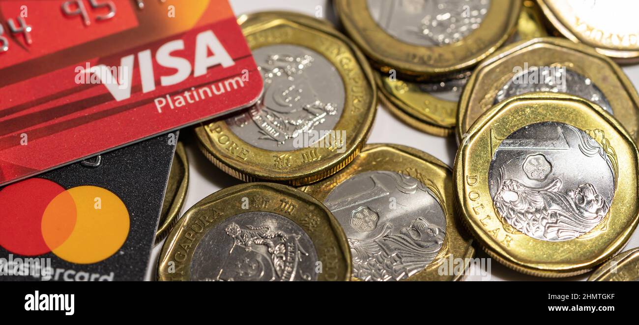 Visa and mastercard credit card and singapore dollar coins. Financial ...