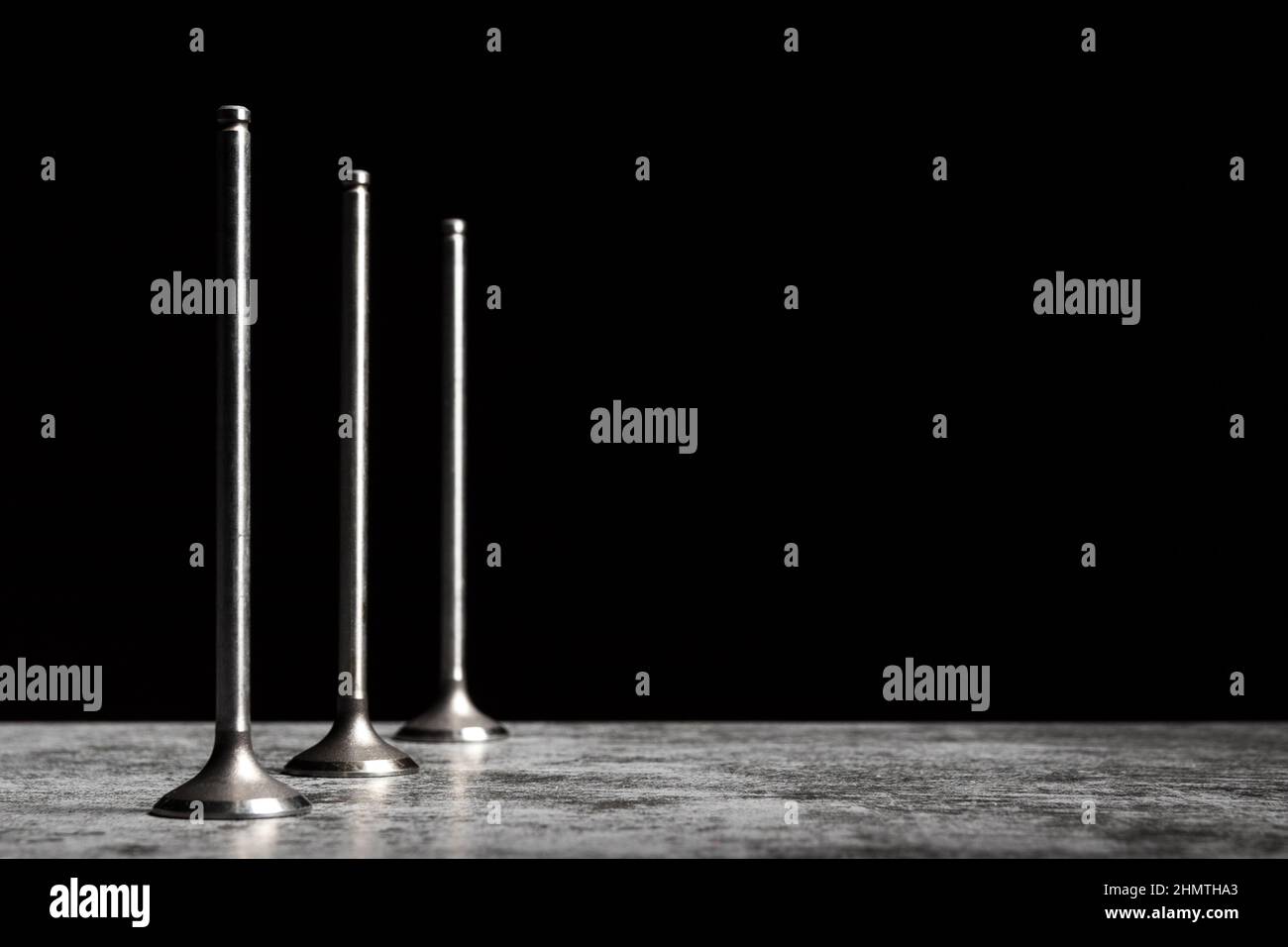 Car engine valves on black background. Part of an internal combustion ...