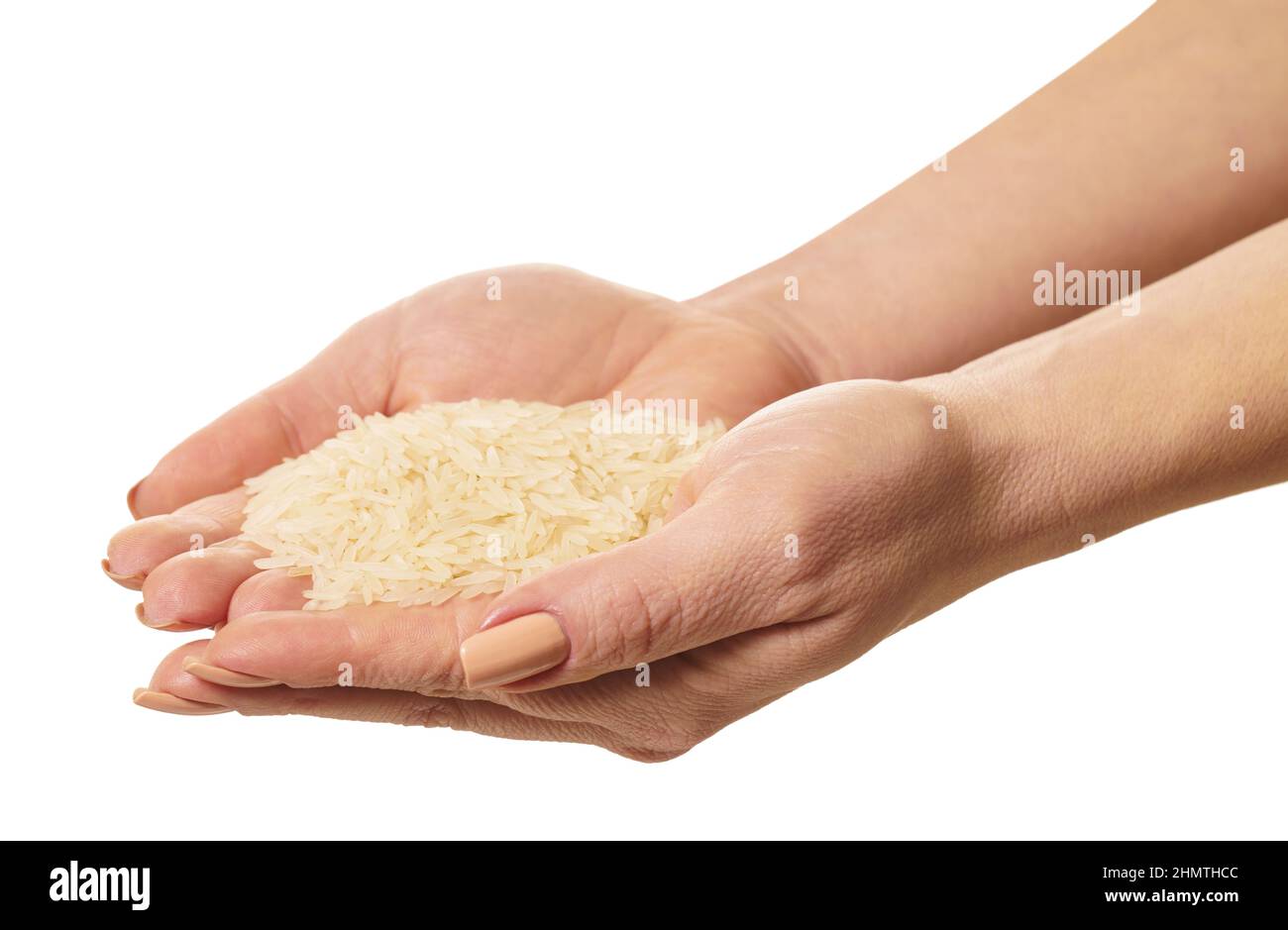 raw rice in hands on a white isolated background Stock Photo - Alamy