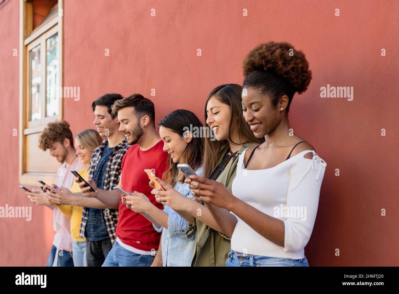 Young Multiracial Group Of Friends Using Mobile Smartphone Outdoor