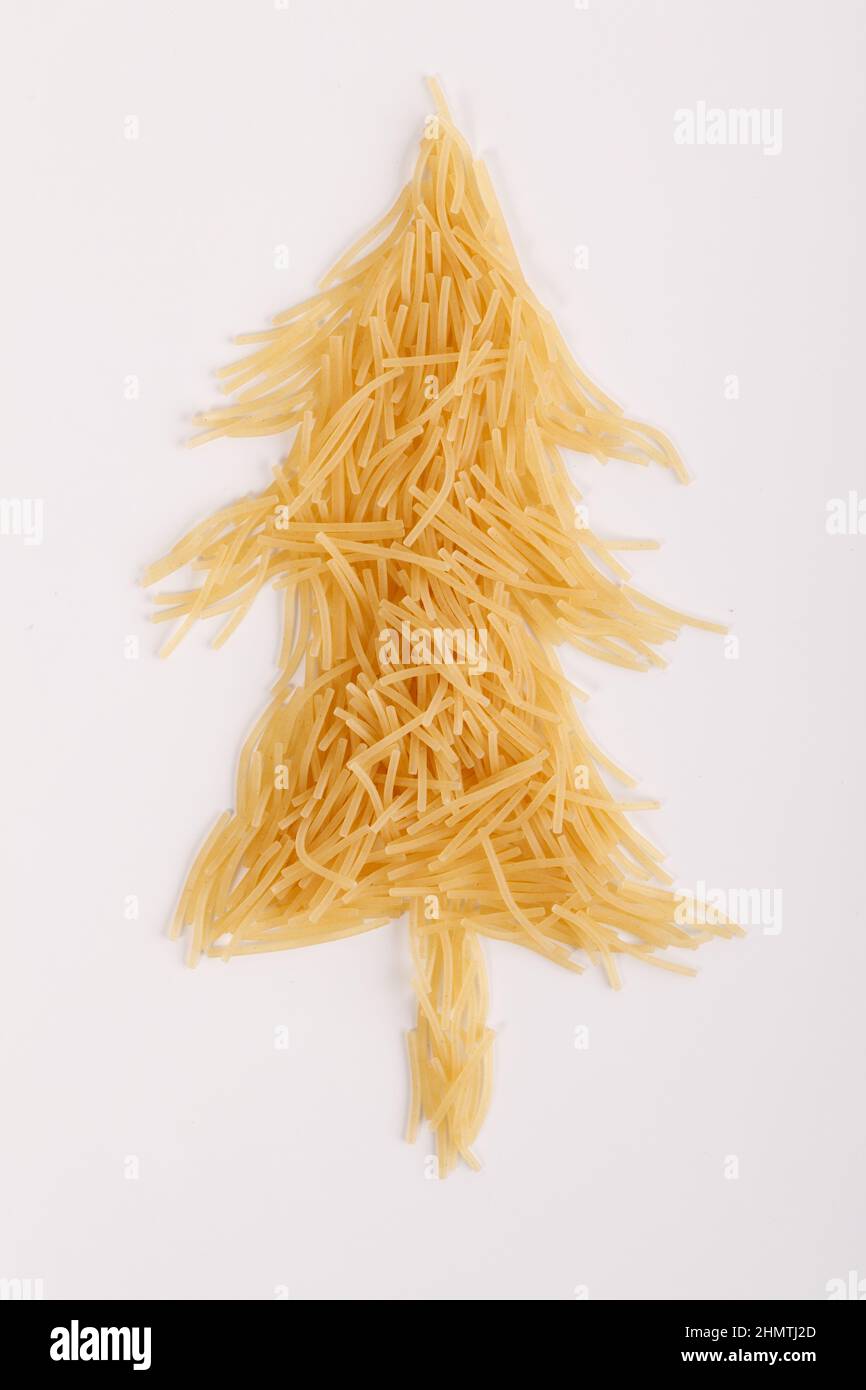 Christmas tree made of raw chopped noodles isolated on white background ...