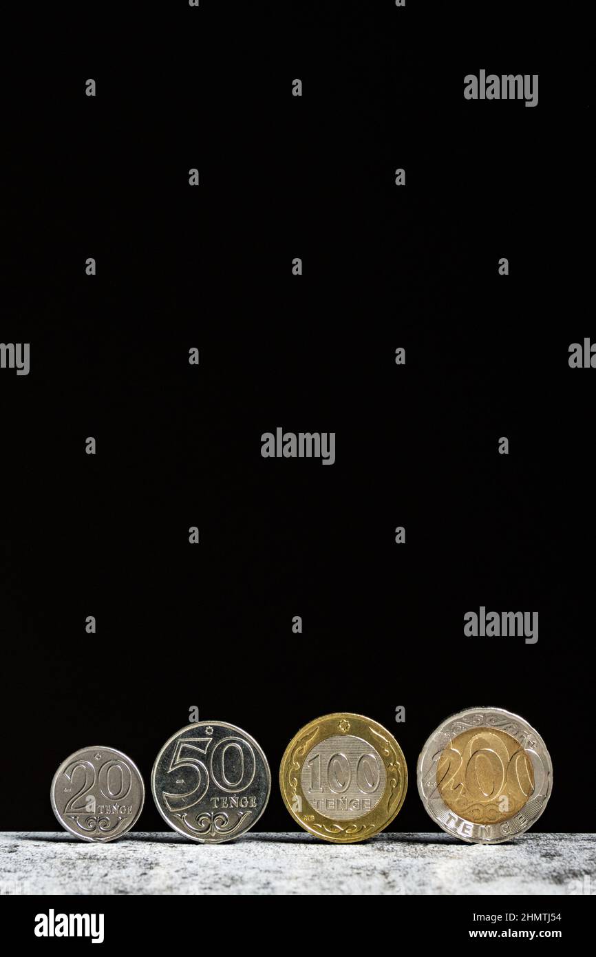 Kazakh coins in denominations of 20, 50, 100 and 200 tenge stand on a ...