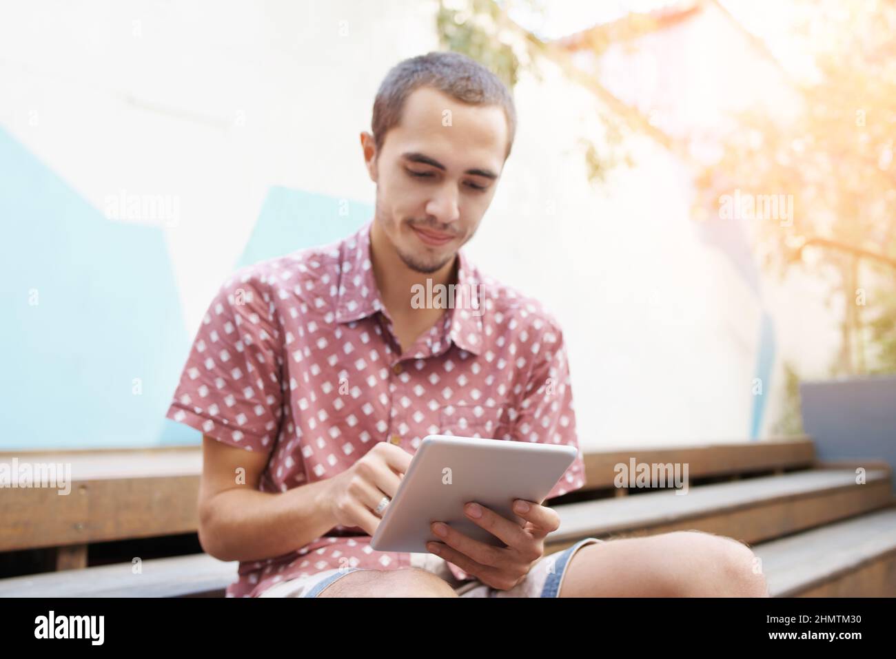 Beefing up his tablet with some new apps Stock Photo - Alamy