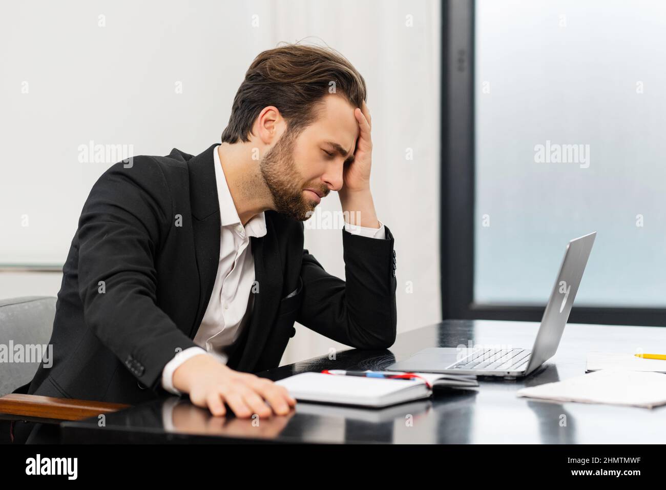 Tired businessman frown while checking financial documents, touching ...