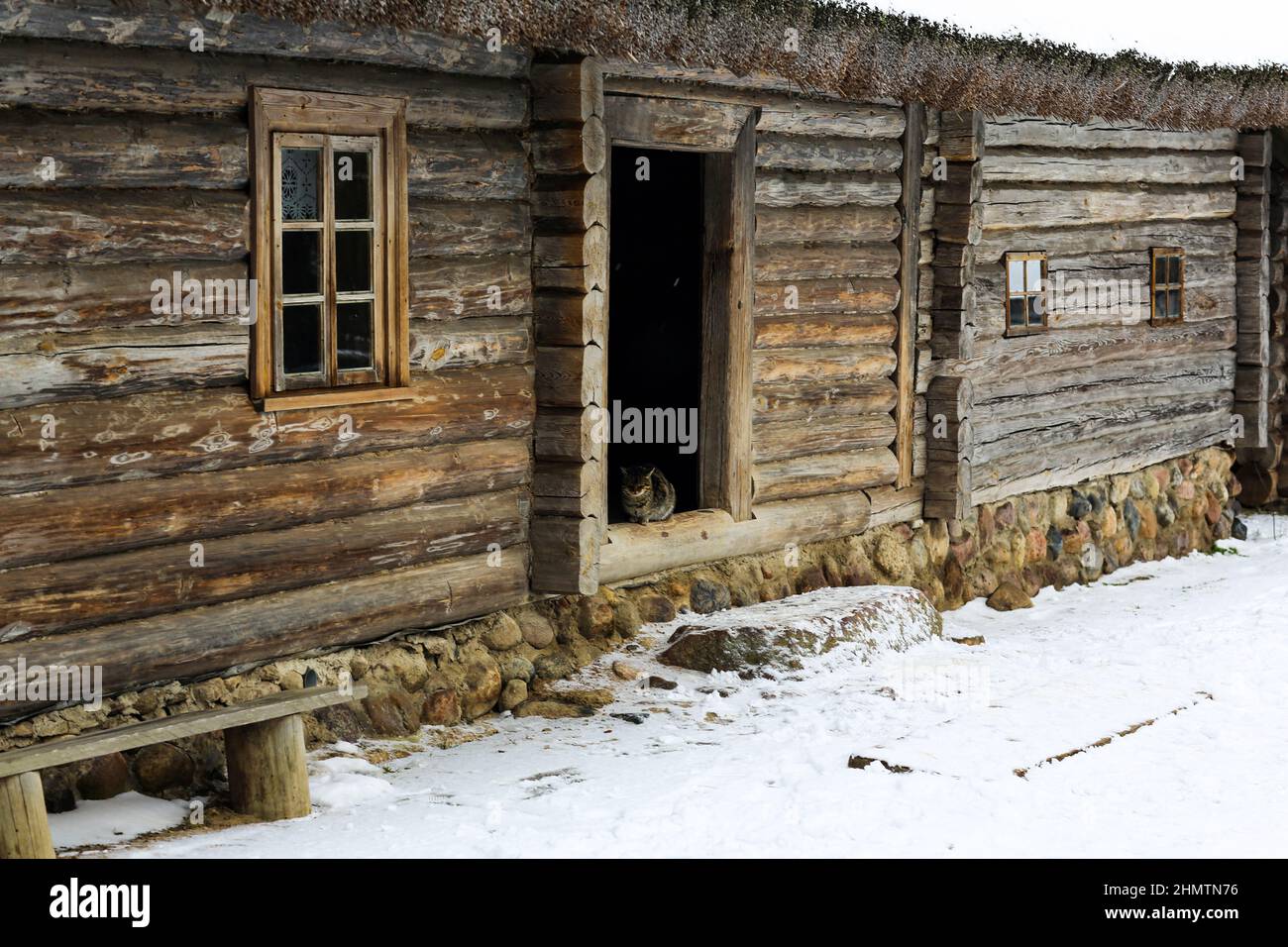 Winter Russian landscape. An old wooden hut, a log house with a ...