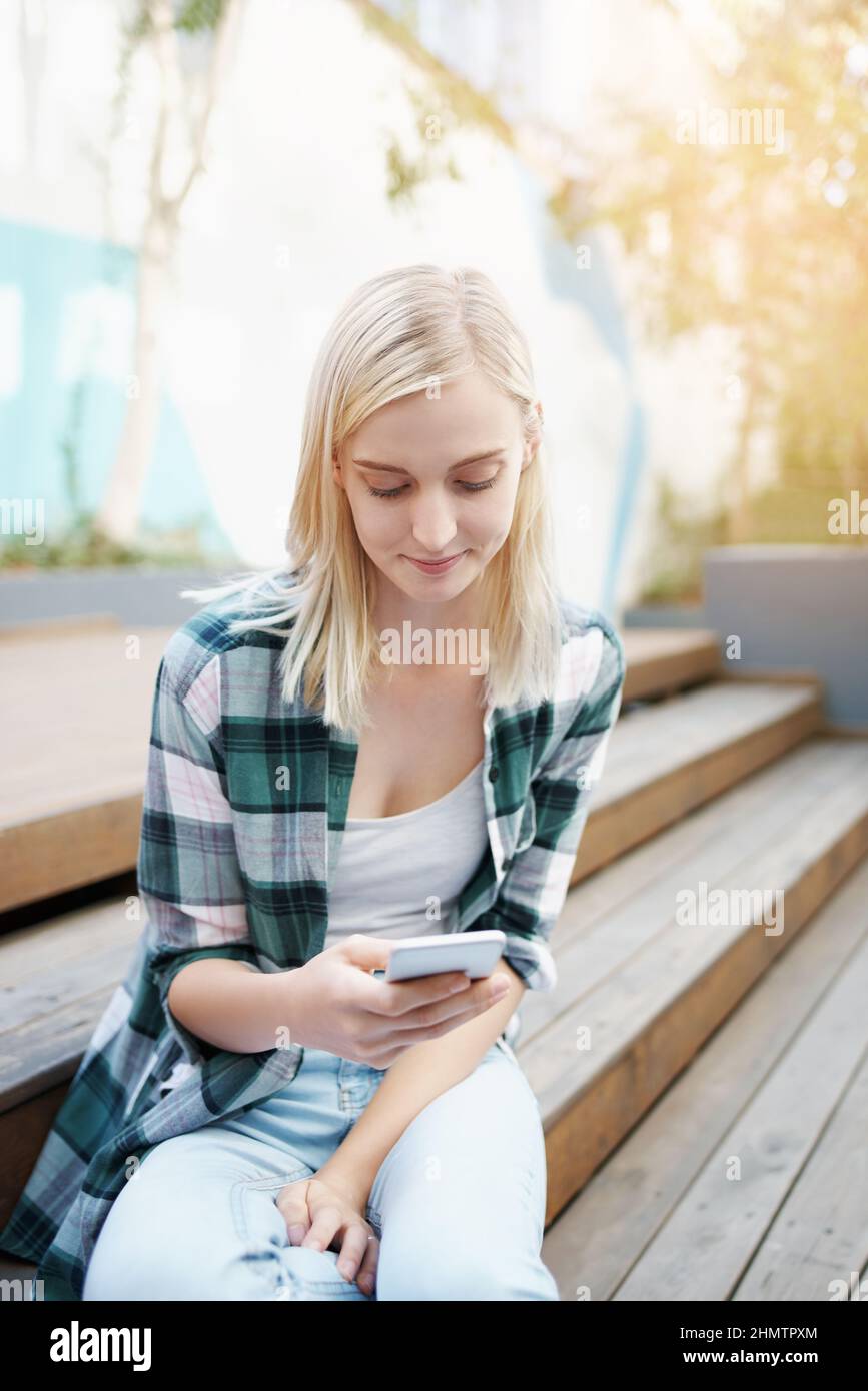 Checking in with her social media accounts Stock Photo - Alamy