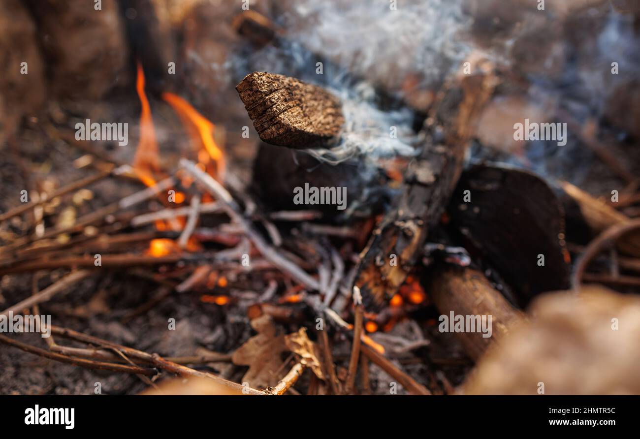Campfire with smoke burning in closeup Stock Photo - Alamy