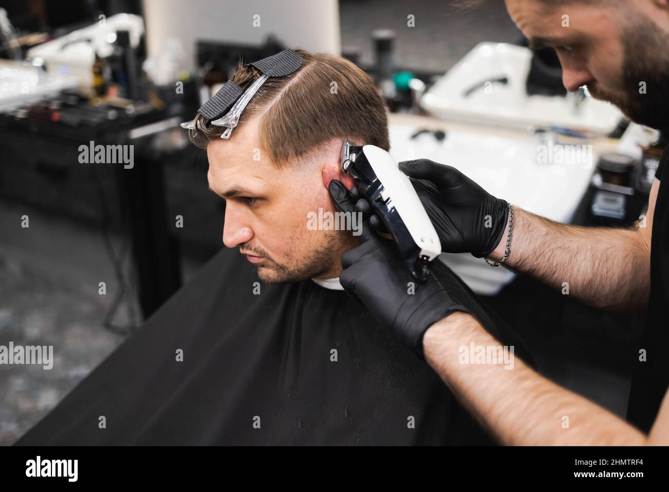 Process of trimming hair in barber shop Stock Photo - Alamy