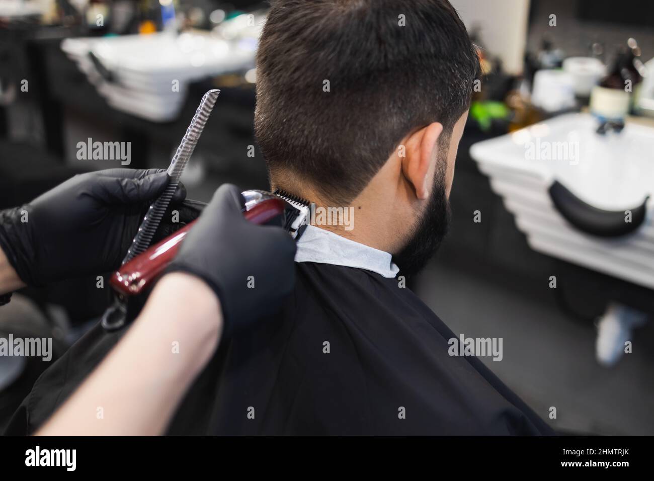 Barber cutting the back of a man's head with electric clipper Stock ...