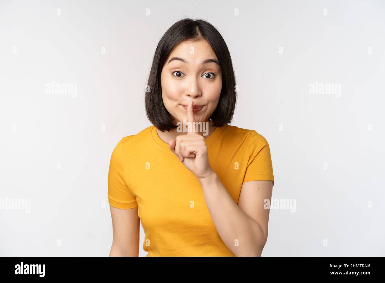 Keep quiet. Cute asian woman make shhh gest, showing shush, hush sign ...