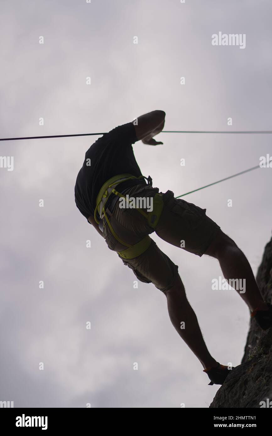 Muscular adult man climbing rocks hi-res stock photography and images ...