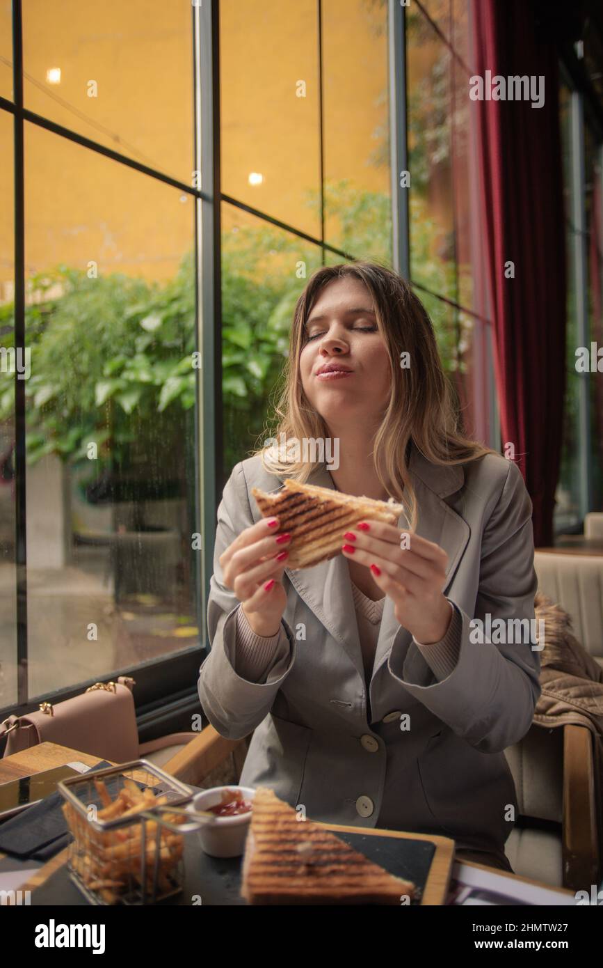 Attractive girl is chewing her food and anjoying it at the same time ...
