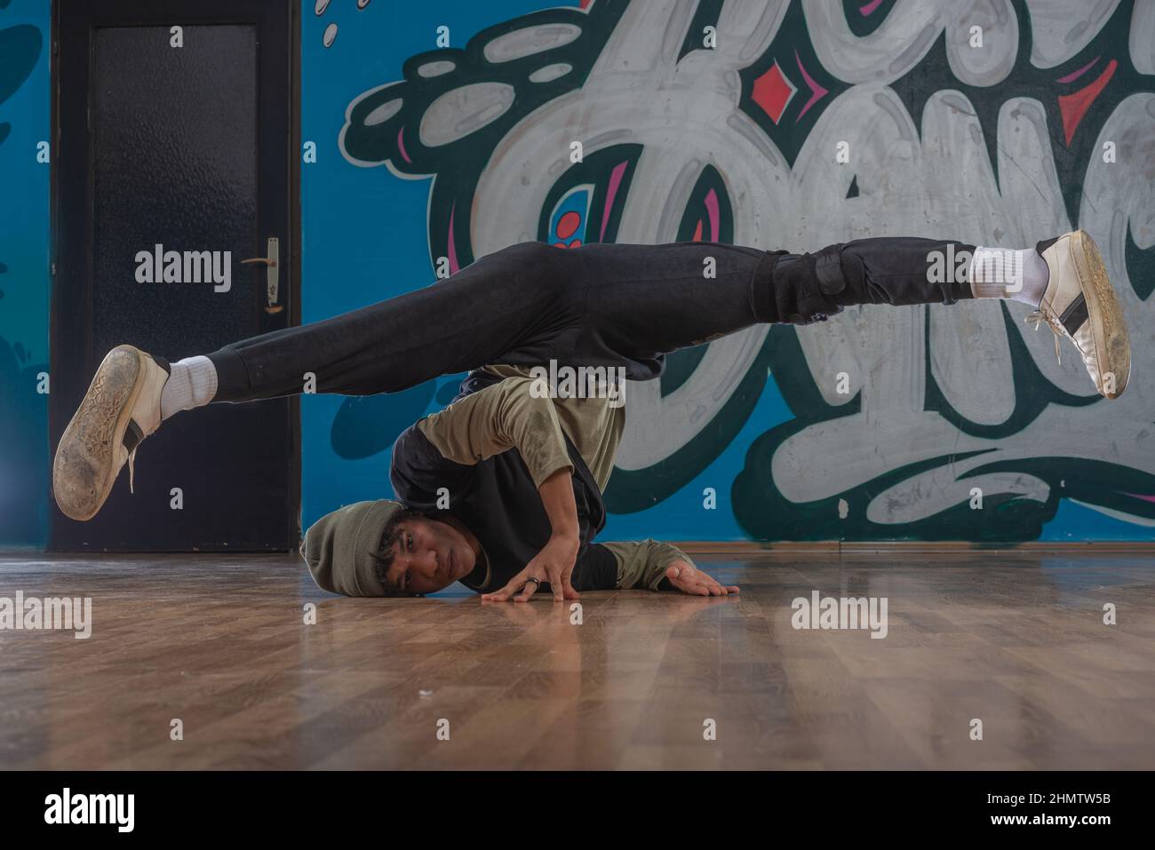 Modern rapper dancing in garage. Urban lifestyle, hip hop Stock Photo ...
