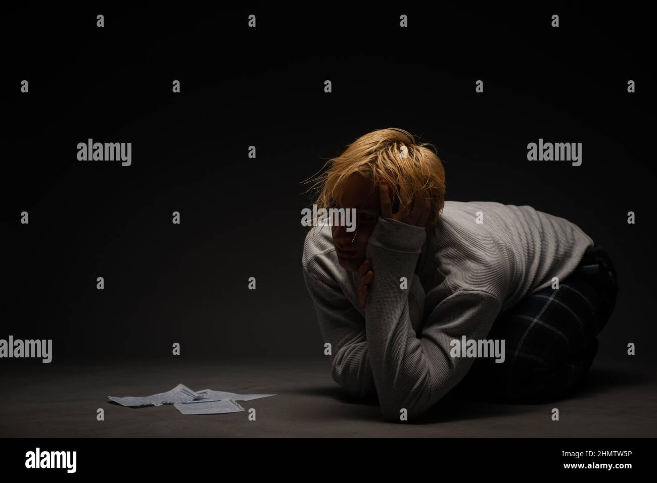 Sad boy is suffering from the inside because of the letters he recived ...