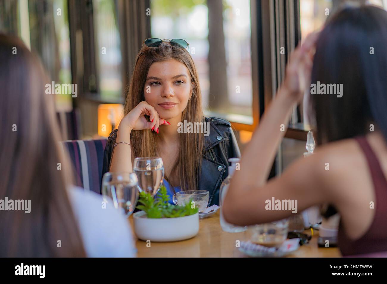 Beautiful and attractive girl is listening and looking at her friend ...