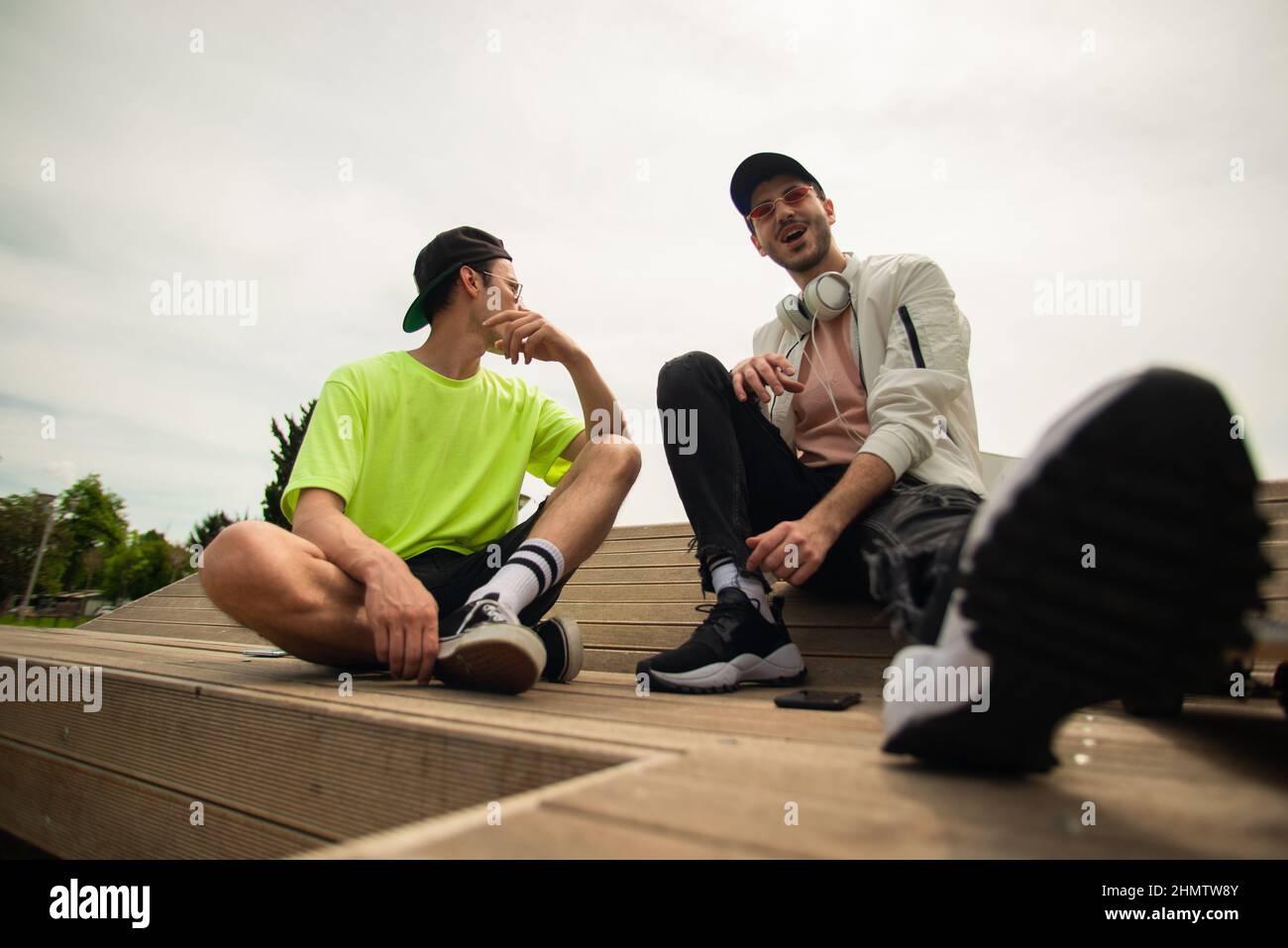 Two guys sitting on bench hi-res stock photography and images - Alamy