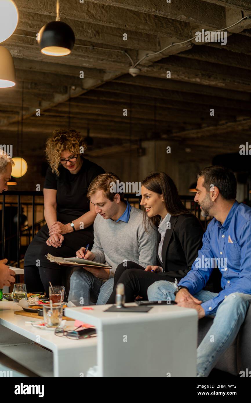 Four amazing business people are listening to their boss for the ...