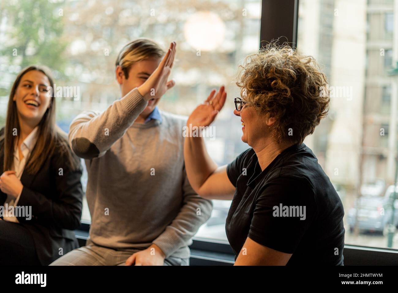 Two amazing and beautiful business people are doing a high five Stock ...