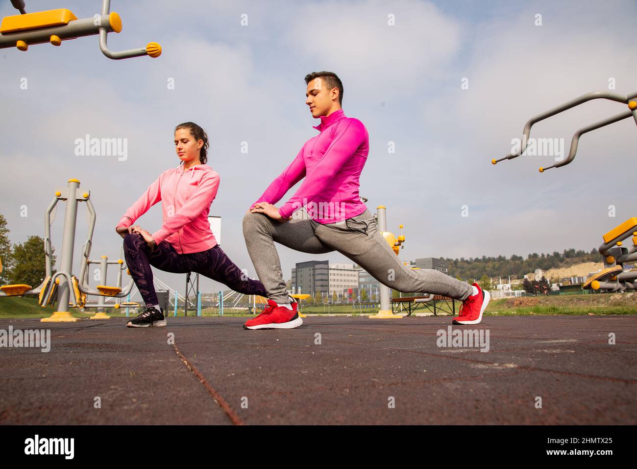 Amazing and attractive fit couple is stretching and warming up together ...