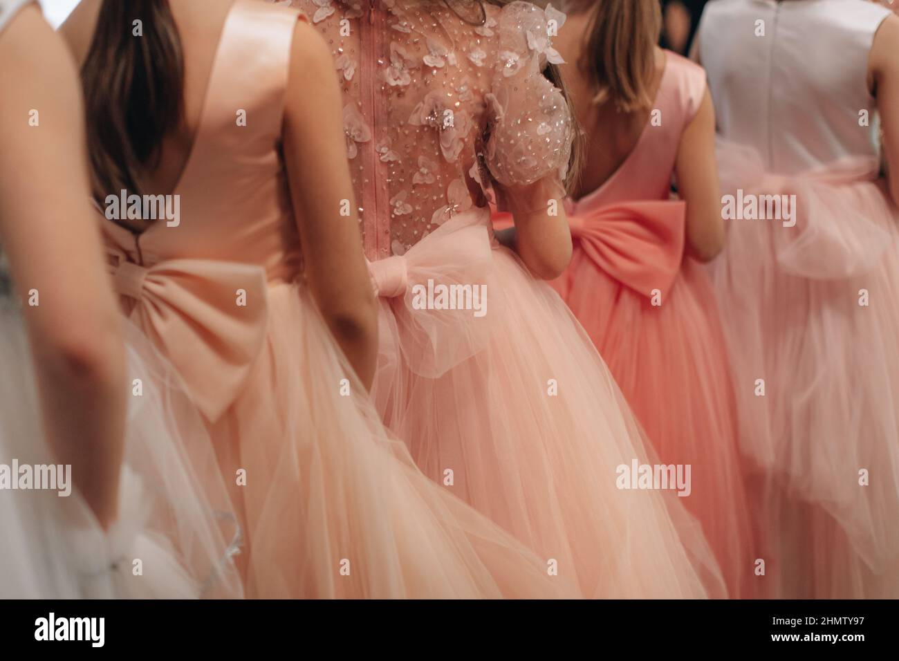 Details of a baby pink fluffy dresses with a pretty bow on the back ...
