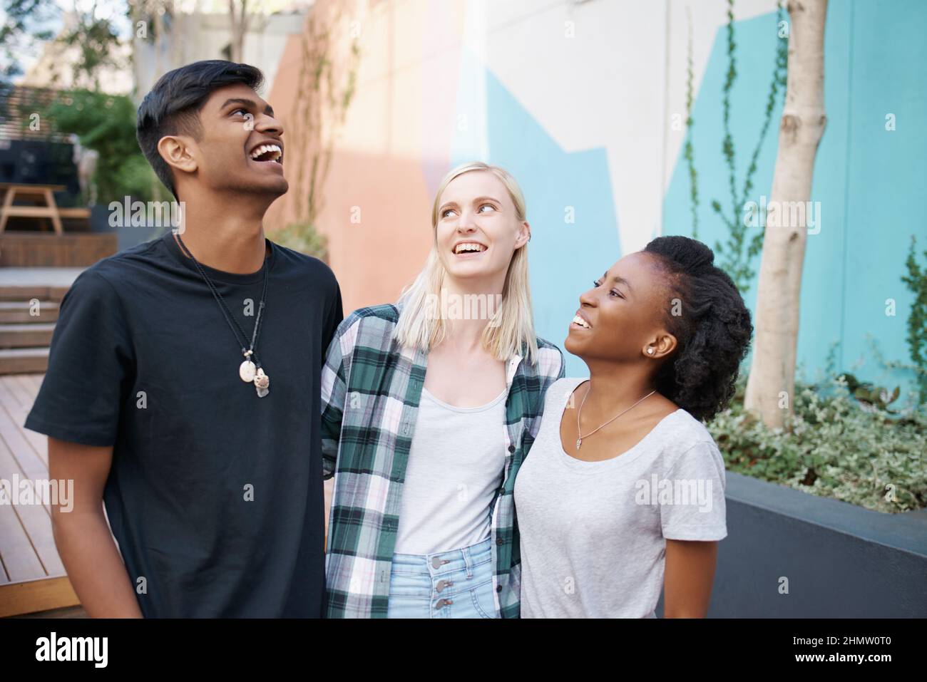 Three diverse friends laughing talking hi-res stock photography and ...